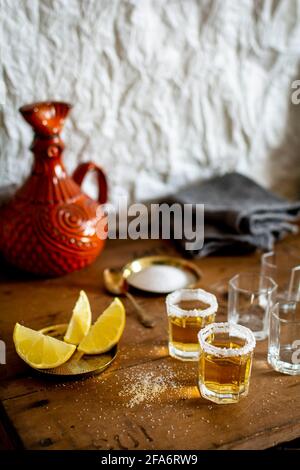 glasses of tequila on the bar table, served with salt and lemon Stock ...
