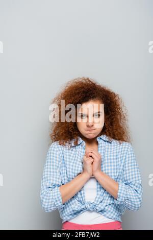 Young Woman with gray hair puffing cheeks and keeping eyes closed while ...
