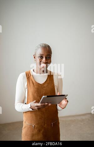 Smiling Afro american woman freelancer working remotely while sitting ...