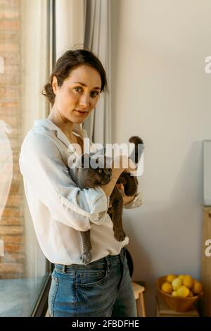 Portrait of a woman holding a cat, interior view Stock Photo - Alamy