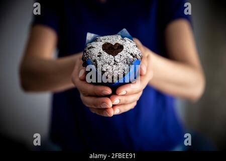 Woman hands holding Valentine's Day gift box on red background. Top ...