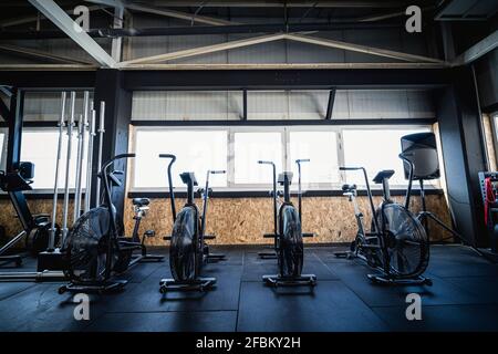 Exercise bikes standing in a row inside a gym. 3D illustration Exercise ...