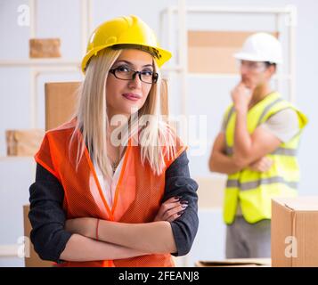 Delivery contractor delivering boxes to office Stock Photo - Alamy