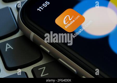 The logo of Alibaba seen in an iPhone on Chinese flag background ...