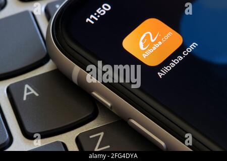 The logo of Alibaba seen in an iPhone on Chinese flag background ...