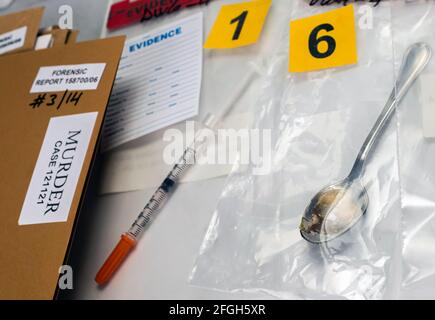 Syringe and spoon in police drug investigation department, concept ...
