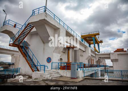 Soviet vintage dam bridge on Shardara river. Close up. Blue sky, clouds ...