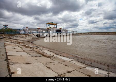 Shardara river dam near Kazaly city.Concrete slab on shore.Gantry crane ...