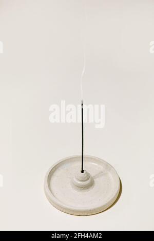 Incense stick in porcelain craft ceramic holder on marble table. Aroma ...