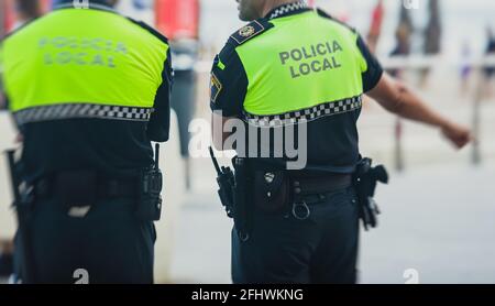 Spanish police squad formation back view with "Local Police" logo ...