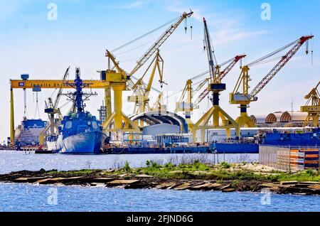 Military warships are under construction at Ingalls Shipbuilding, a ...