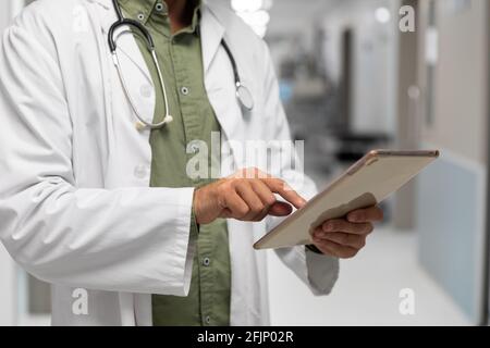 Midsection of caucasian male doctor with stethoscope, pen and ...