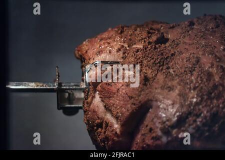 pork roast spinning and dripping fat on a rotisserie Stock Photo - Alamy