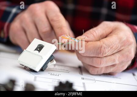 Electrician hands preparing an internet connection; multiple exposure ...
