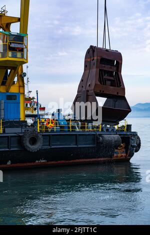 Batumi, Georgia - 08 February 2021: Yellow crane in a cargo port ...
