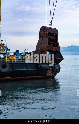 Batumi, Georgia - 08 February 2021: Yellow crane in a cargo port ...