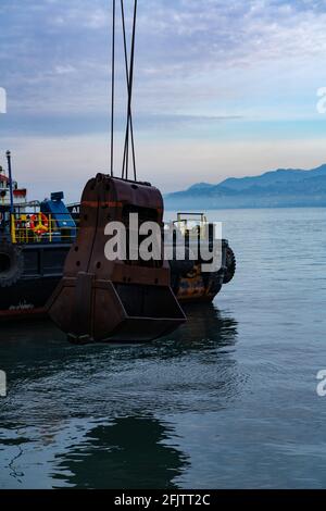 Batumi, Georgia - 08 February 2021: Yellow crane in a cargo port ...