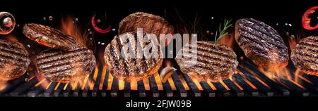 Grilled beef steaks in motion falling down on open grill. Conceptual ...