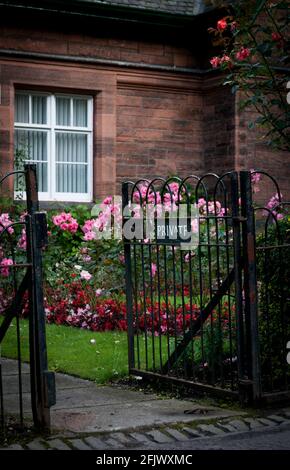 Front private entrance with metal railings to the flower garden of a ...