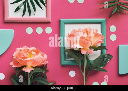 Pink peony in white frame, palm leaves. Creative flat lay, top view on ...