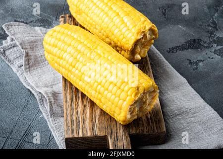 Tasty corn cobs set, on black stone background, top view flat lay, with ...