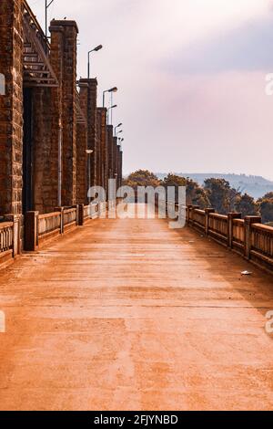 Beautiful alley by a stone bridge columns on a sunny day Stock Photo ...