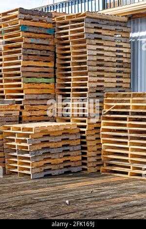 group of old wooden pallet stacked outside wharehouse ready for the ...