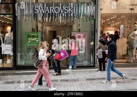 Swarovski logo is seen as people walk in front of the shop on landmark ...