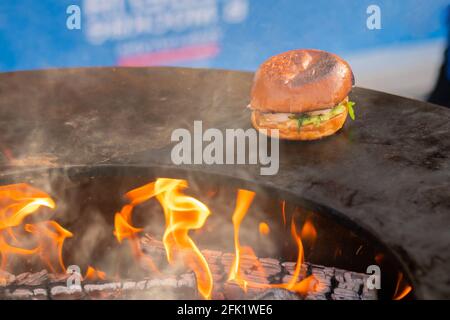 Process of preparing burger with seafood on brazier at summer local ...