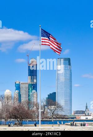 American Flag flying in the wind outside an office building in midtown ...