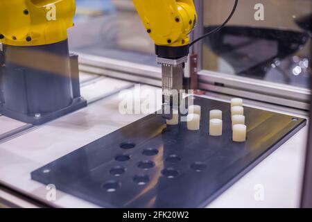 Automated robotic clamp arm moves and places objects at trade show ...