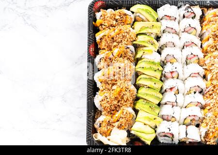 Pre-packaged variety of sushi and sushi rolls in a plastic tray Stock ...