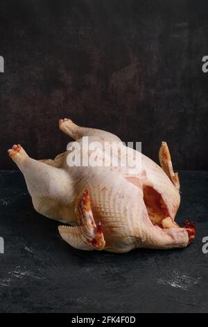 Whole raw turkey carcase on dark background Stock Photo - Alamy