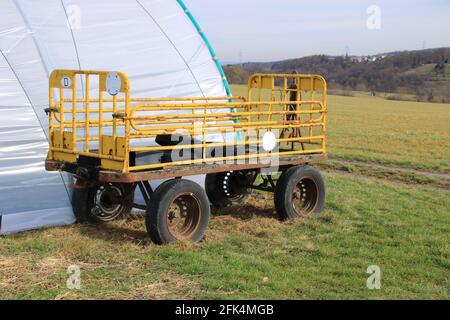 Old yellow trailer for transporting material in a meadow Stock Photo ...