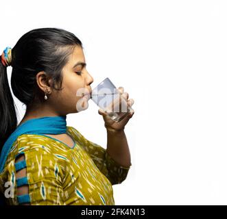 Asian woman drinking water on beige background Stock Photo - Alamy