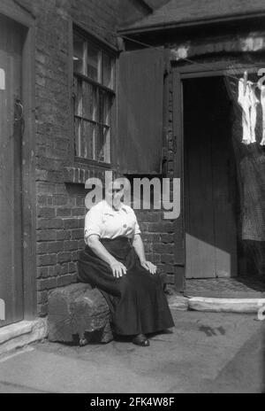 circa 1930s, historical, outside on a bumpy path, a sweet young girl ...