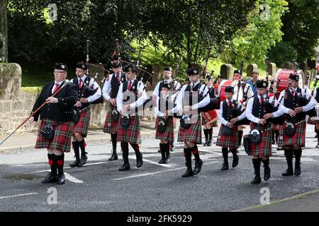 Scottish Highland bagpipers playing pipes and drums in moorland ...