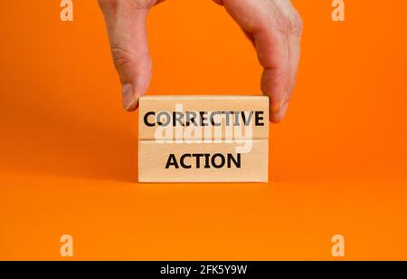 Corrective action symbol. Wooden blocks with words 'Corrective action ...