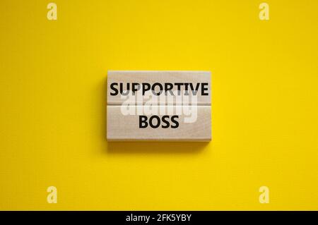 Supportive boss symbol. Wooden blocks with words 'Supportive boss' on ...