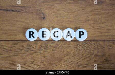 Recap symbol. Wooden circles with word 'recap' on a beautiful ...