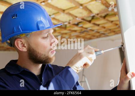 a male builder during window installation process Stock Photo - Alamy