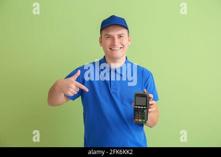 Courier with payment terminal on color background Stock Photo - Alamy