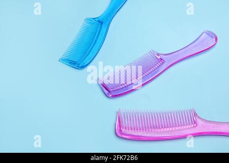 Plastic hair combs on color wooden background Stock Photo - Alamy