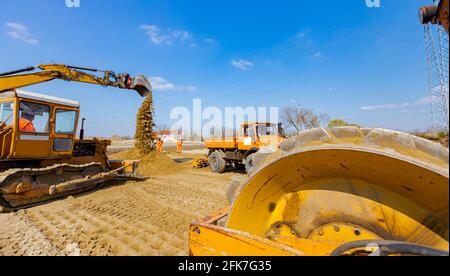 Road roller with spikes, bulldozer and truck with mounted plate ...