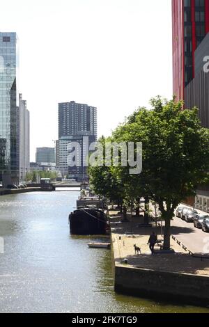 ROTTERDAM, NETHERLANDS - May 28, 2011: Buildings and boats by the water ...