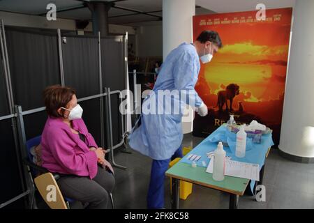 Nurse administering astrazeneca or pfizer to an old lady in a box in ...