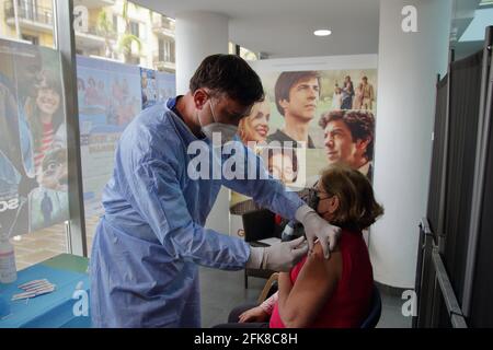 Nurse administering astrazeneca or pfizer to an old lady in a box in ...