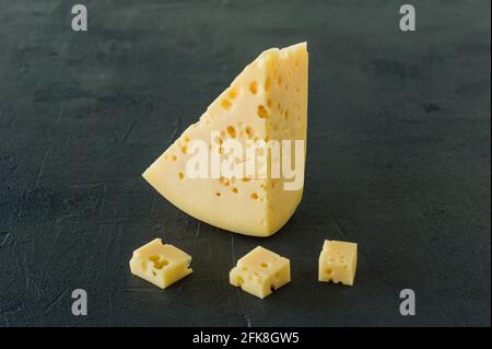 Radamer cheese on a plate served with honey. triangular piece of yellow ...