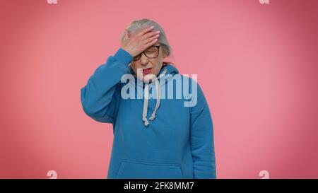 Upset stylish senior woman making face palm gesture, feeling bored ...