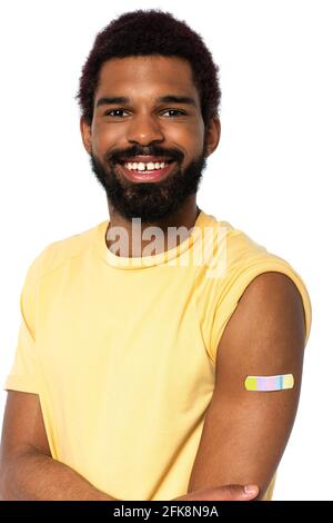 Coronavirus immunization. Positive black man showing his arm with an ...